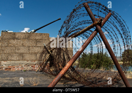 Coiled barbed wire on a gun emplacement. Black and white image Stock ...