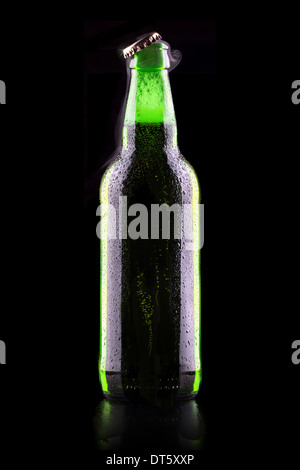 Cold beer bottle with chill smoke on black background Stock Photo - Alamy