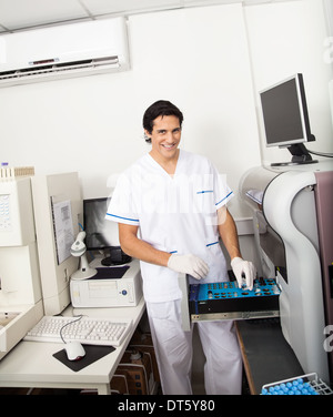 Scientist Loading Coagulation Analyzer With Samples Stock Photo - Alamy