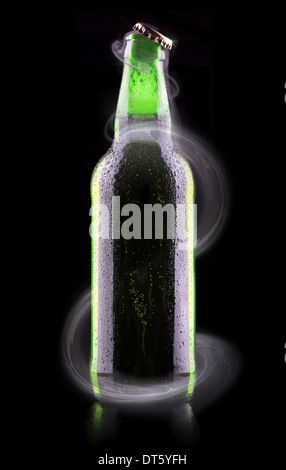 Cold beer bottle with chill smoke on black background Stock Photo - Alamy
