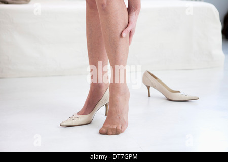 leg cramp, senior woman suffering from leg cramp pain at home, health ...