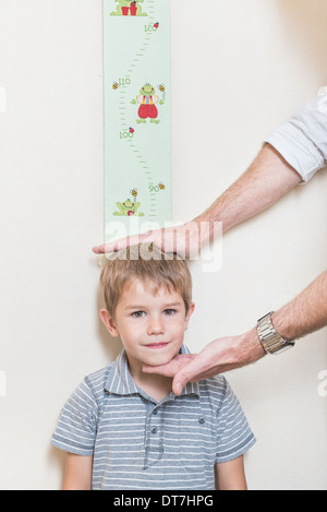 General practitioner measuring the height of a patient during medical ...