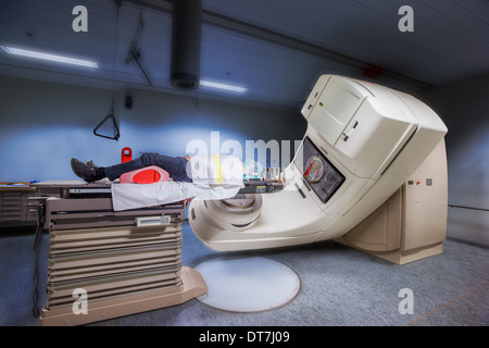 Male cancer under a linear accelerator or linac receiving radiation ...