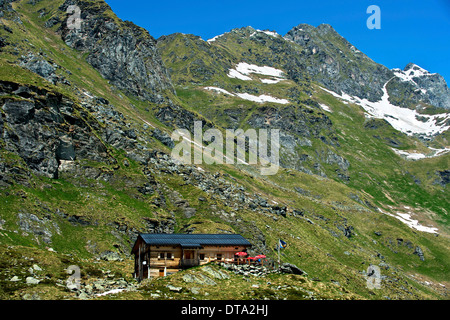 Mountain hut Cabane de Louvie at lake Louvie, peak Becca d'Agè behind ...