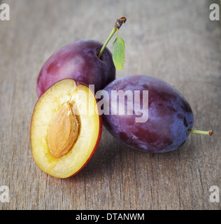 three yellow plums on rustic table, wood surface Stock Photo - Alamy