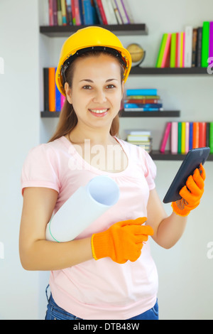 young professional engineer worker in protective helmet and blueprints ...