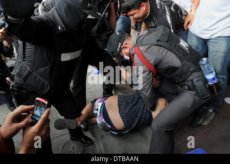 Riot policemen arrest an anti-government protester, during a protest in ...