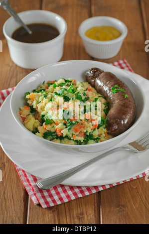 Stoemp and sausage. Mashed potatoes with carrots and spinach. Belgium ...