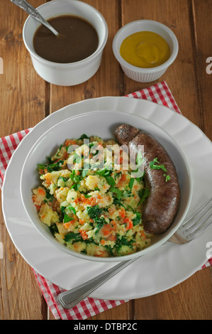 Stoemp and sausage. Mashed potatoes with carrots and spinach. Belgium ...