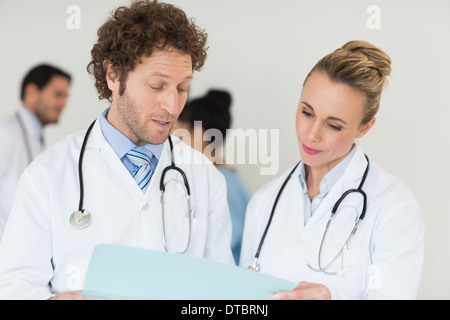 Medical team discussing over file Stock Photo - Alamy