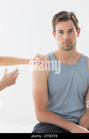 Man receiving injection on arm Stock Photo - Alamy