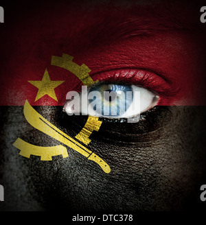 Portrait of a woman with the flag of the Angola painted on her face ...