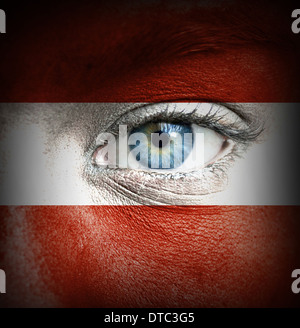 A fan with Austria flag face paint waits for the start of the World Cup ...