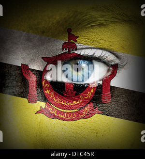 Woman face painted with flag of Brunei Stock Photo - Alamy