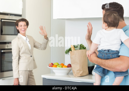 Caucasian father waving goodbye to his family before going to work ...