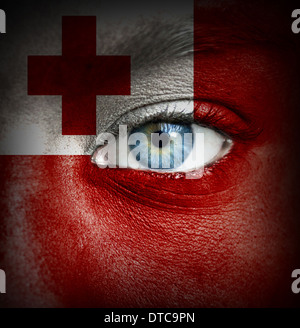 A young female with the flag of Tonga painted on her face on her way to ...