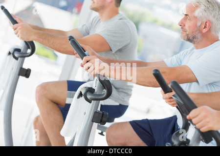 Men using exercise bikes Stock Photo - Alamy