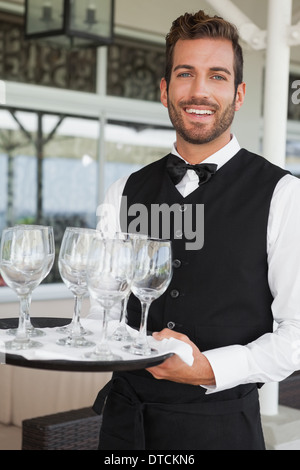 Young hispanic man holding tray with take away coffee skeptic and ...