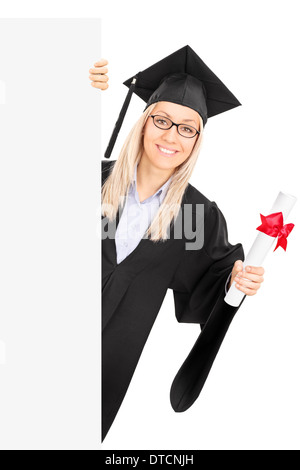 Pretty female student posing behind a white panel isolated on white ...