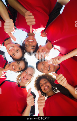 Sports, huddle and football team with their hands together on the ball ...