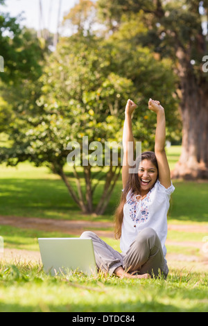 Happy and excited woman raising hands and shouting with joy celebrating ...