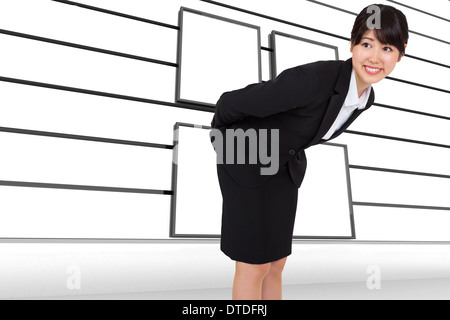 Composite image of smiling businesswoman bending Stock Photo - Alamy