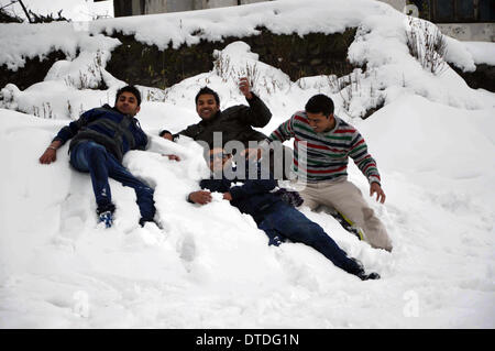 Mussoorie, India. 15th Feb, 2014. A man walks past a snow-covered road ...