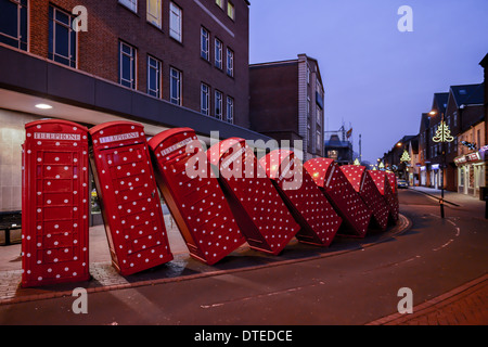 English red telephone boxes falling over each other Stock Photo - Alamy