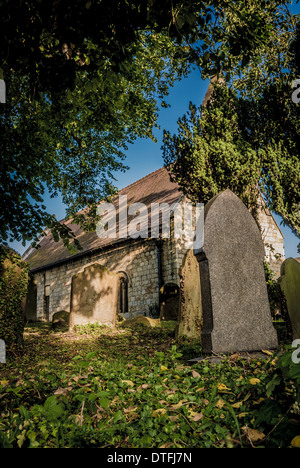 Gravestones at graves in a churchyard cemetery at a church in England ...