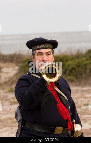 A lone bugler plays taps along Breach Inlet in honor of the sailors of ...