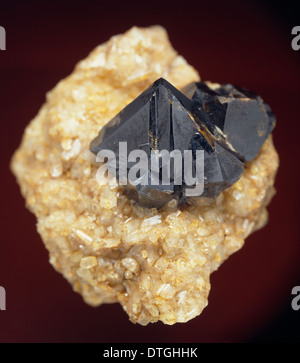 Cassiterite, tin oxide mineral, tin ore isolated on black background ...