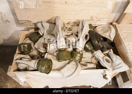 Many gas masks with green balloon in a chest Stock Photo - Alamy