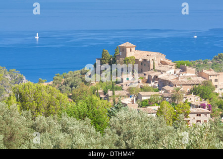 Church of Deià village and sailboat. sea. Majorca, Balearic islands ...