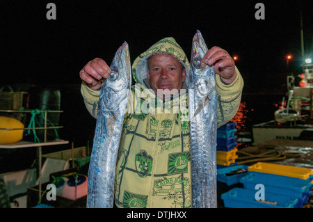 Fisherman holds Silver scabbardfish (Lepidopus caudatus). San Miguel ...