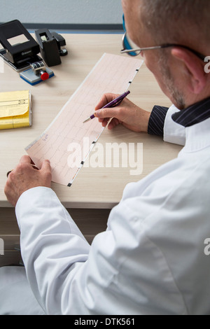 Doctors office. Doctor explains the result of an ECG cardiac ...