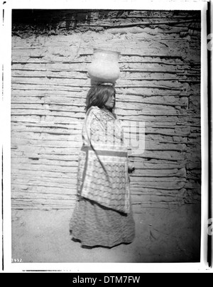 A historical photograph of a Yuma Indian woman sitting in the shadow of ...