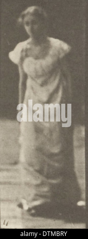 A woman in a long dress is stooping and lifting a handkerchief ...