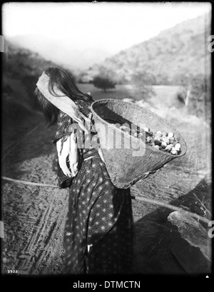 This photograph shows a Yokut Indian woman making baskets on the Tule ...
