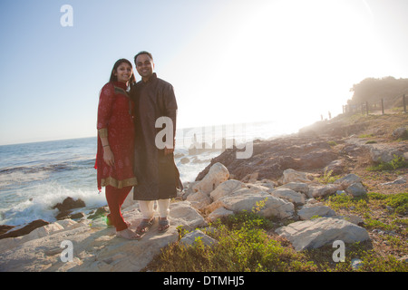 indian couple walk jump and hug each other beachside oceanside seaside ...
