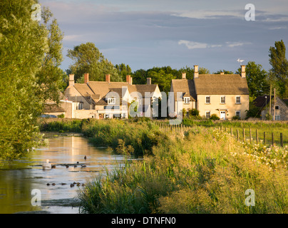 Cottages near the River Coln at Fairford in the Cotswolds ...