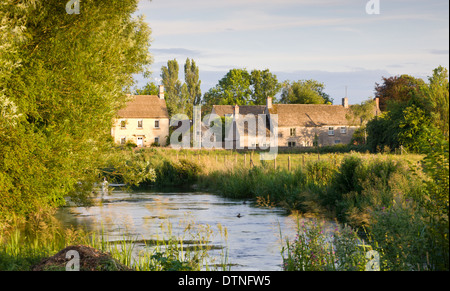 Cottages near the River Coln at Fairford in the Cotswolds ...