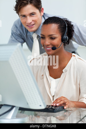 Assertive businesswoman helping her colleague Stock Photo - Alamy