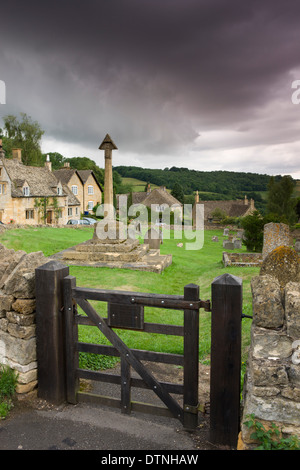 Snowshill village churchyard and cottages in the snow in January ...