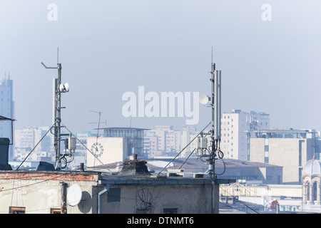 Radio mast on rooftop against blue sky Stock Photo - Alamy