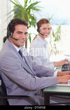 Side view of call center agents doing their work Stock Photo - Alamy
