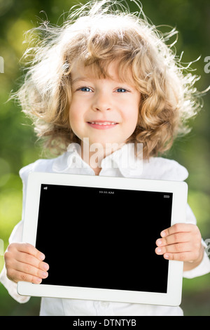 Child holding white tablet PC in hands Stock Photo - Alamy