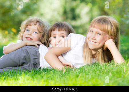 Kids playing in spring park. Children running in sunny garden with ...