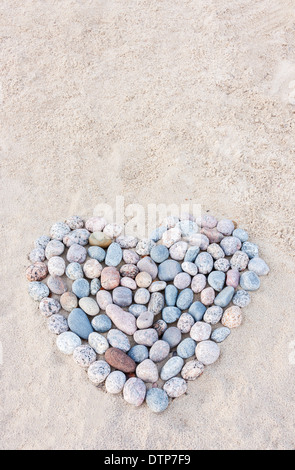 Heart shape made on the sand background in view Stock Photo - Alamy