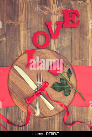 Table setting for Valentine's Day with rose on grey background Stock ...