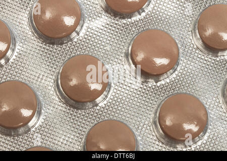 closeup of a pack of brown pills isolated white background Stock Photo ...
